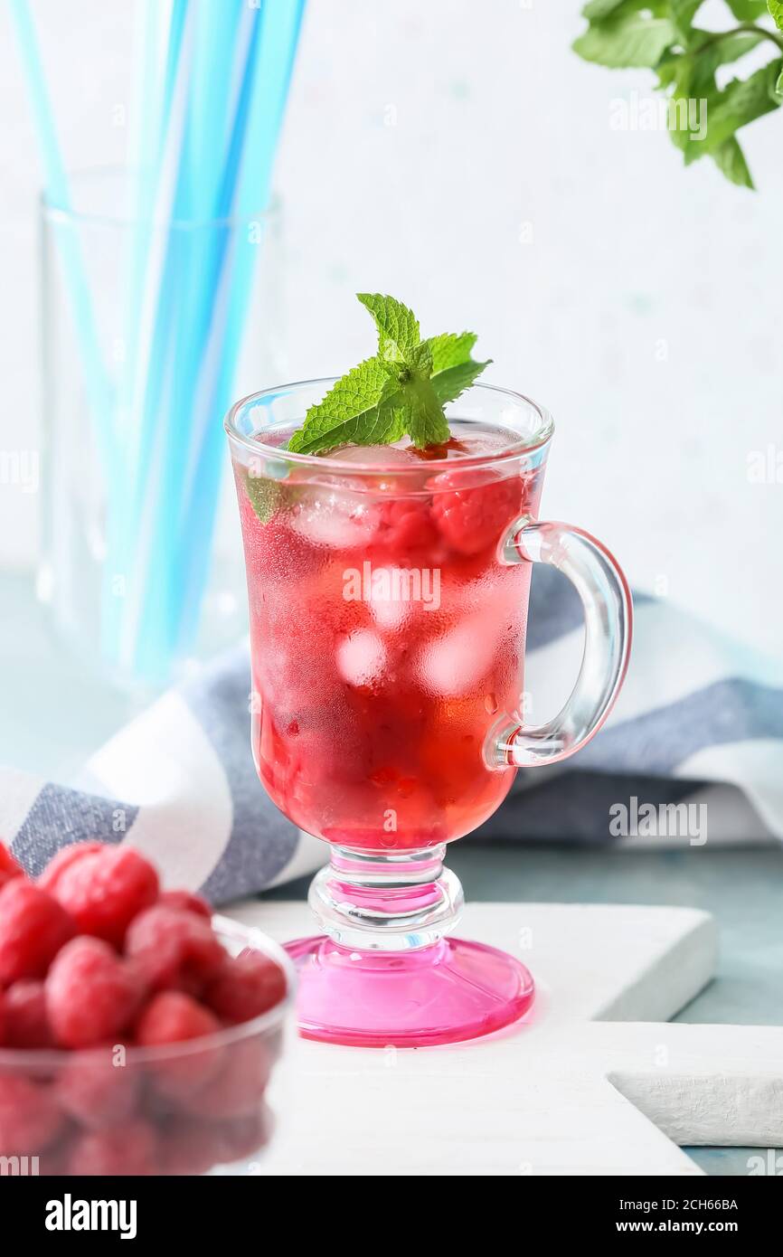 Cup of cold raspberry tea on table Stock Photo - Alamy