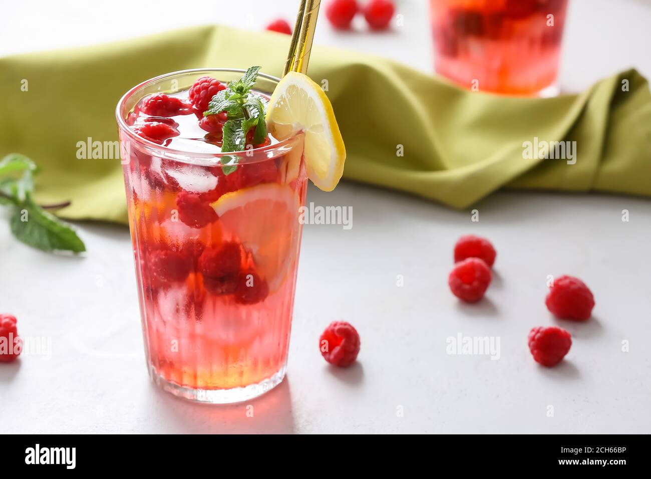 Glass of cold raspberry tea on white background Stock Photo - Alamy