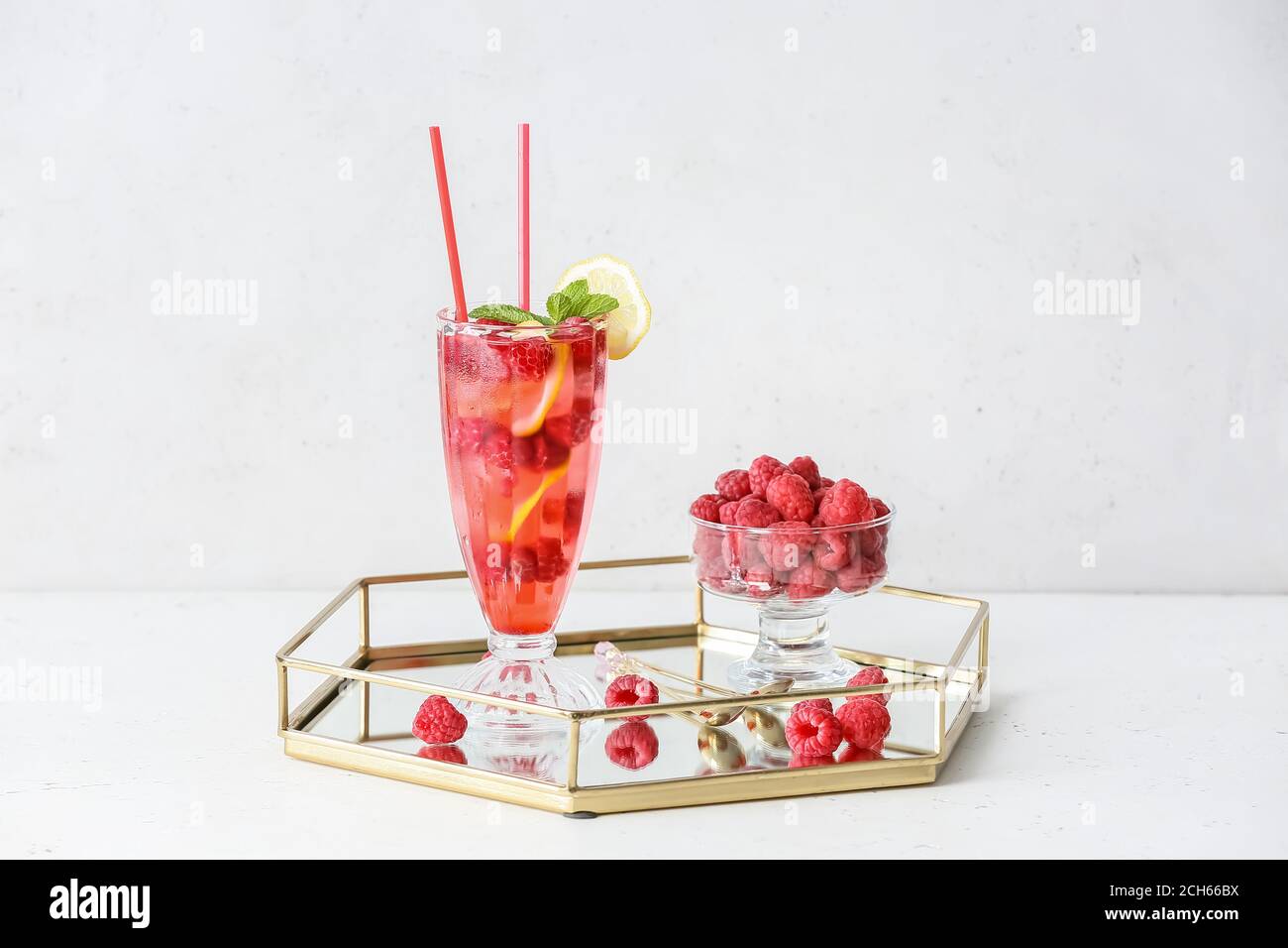 Glass of cold raspberry tea on white background Stock Photo - Alamy