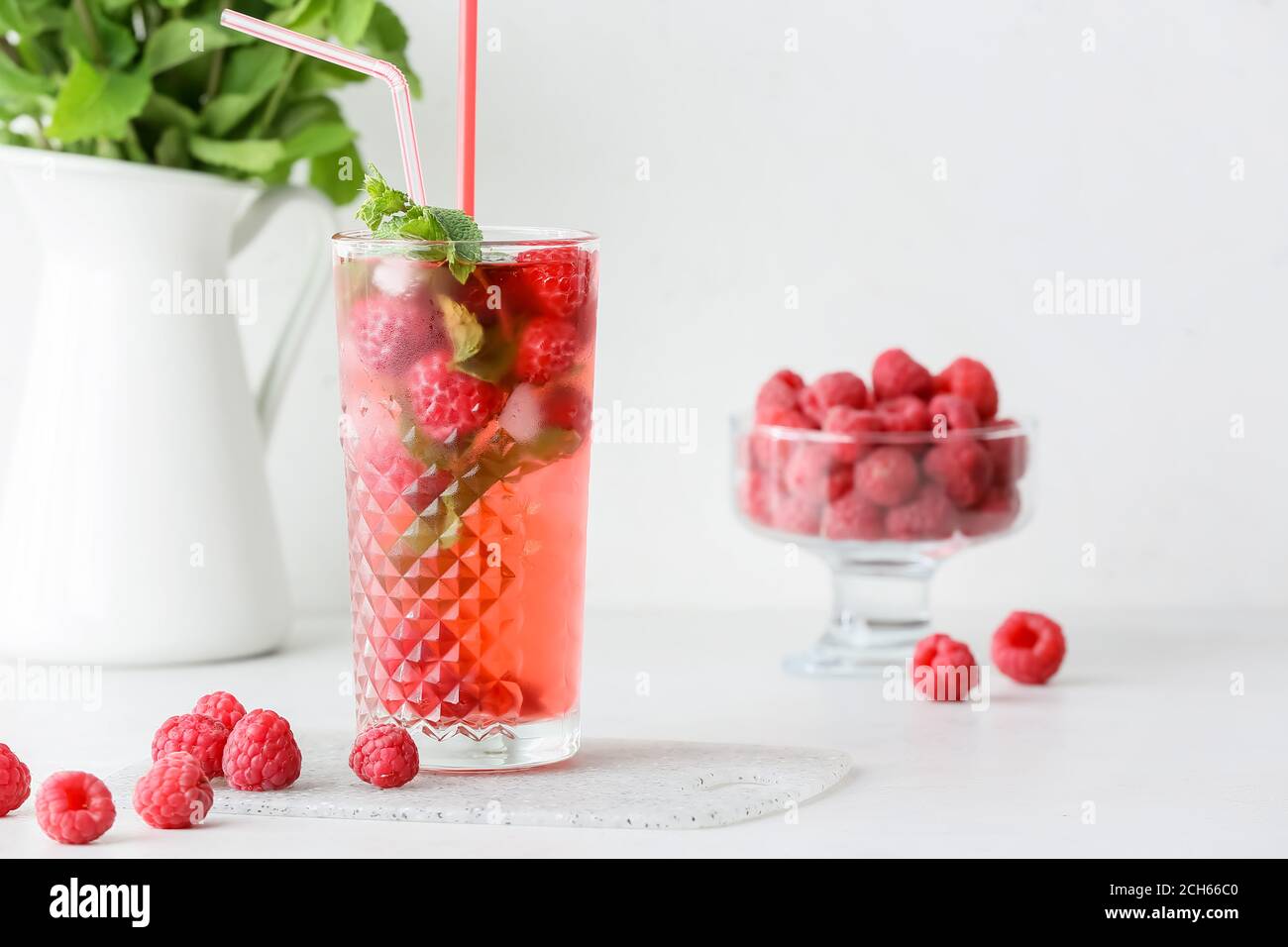 Glass of cold raspberry tea on white background Stock Photo - Alamy