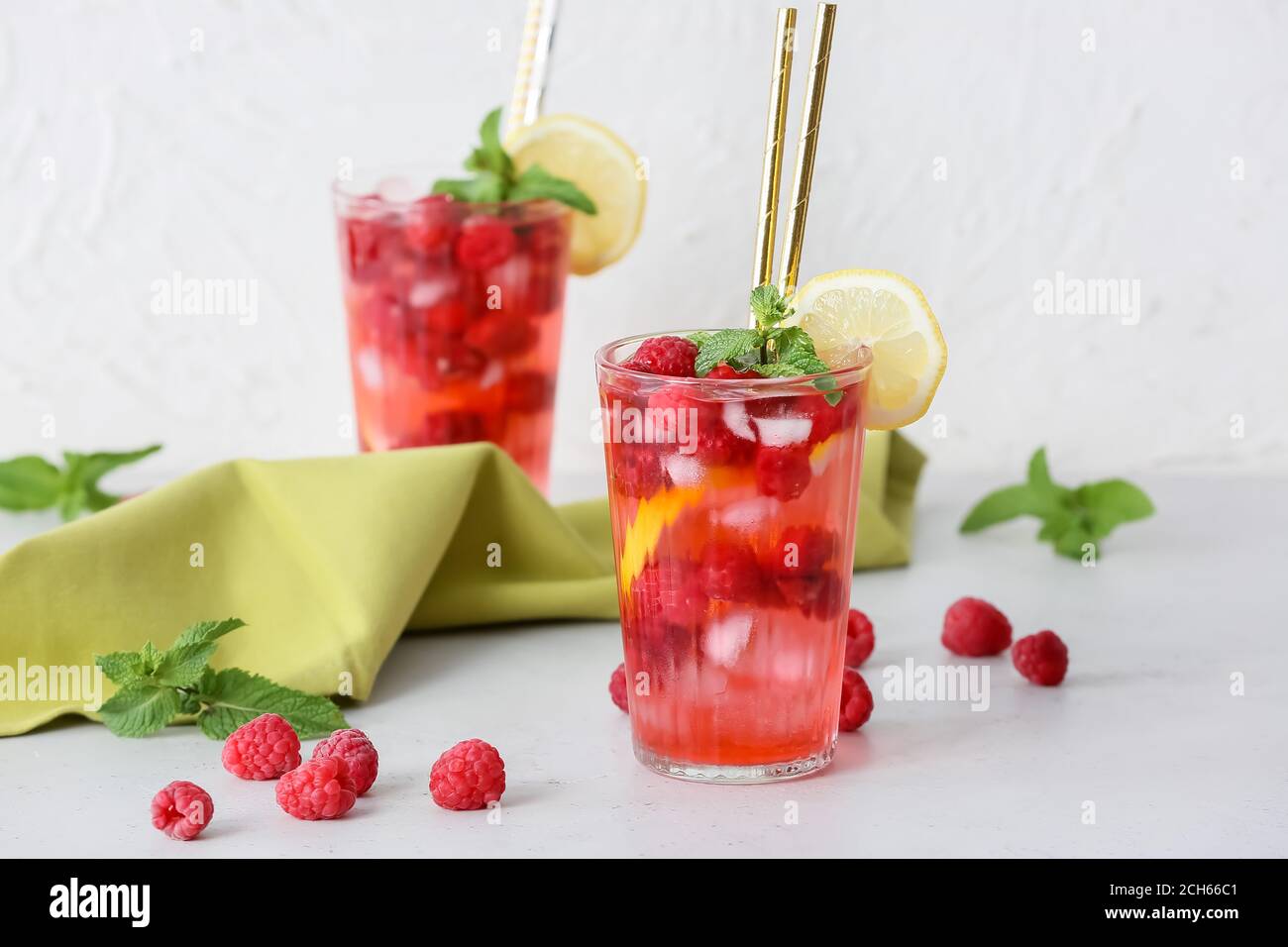 Glass of cold raspberry tea on white background Stock Photo - Alamy