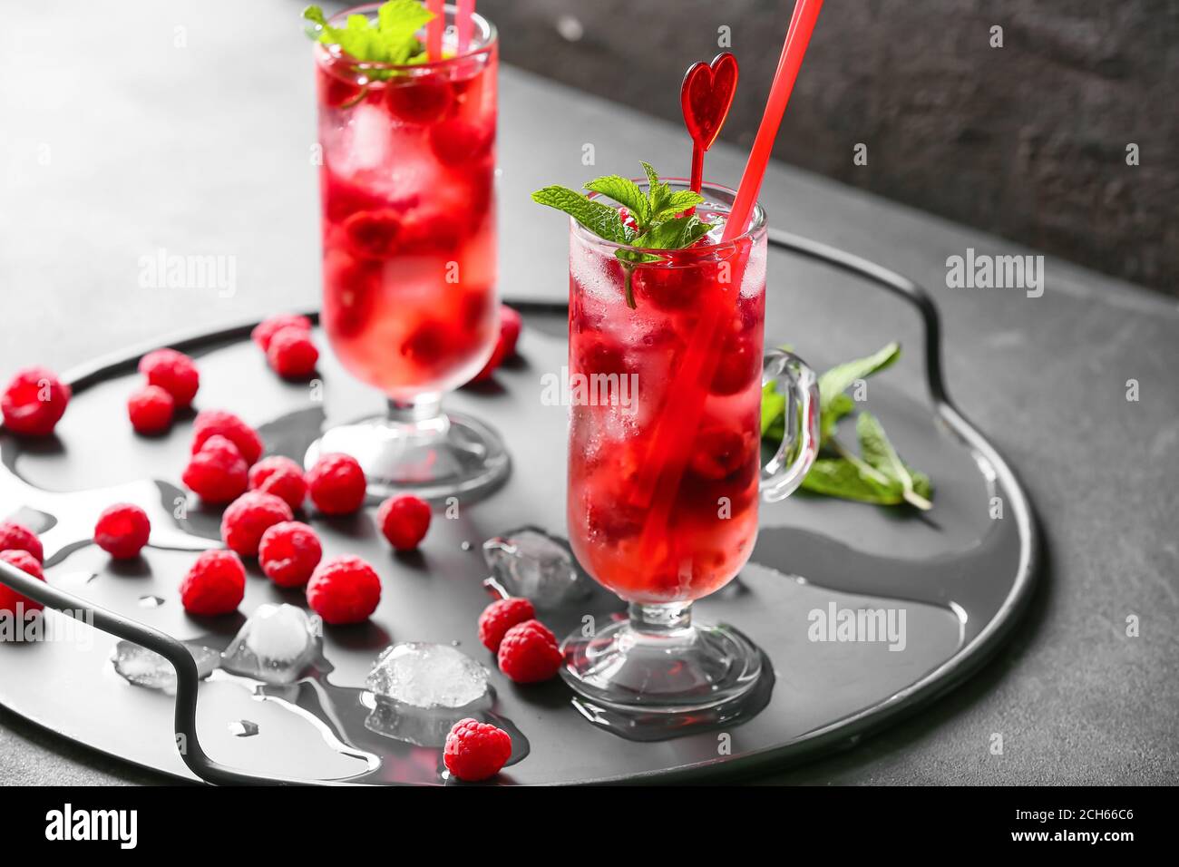 Cups of cold raspberry tea on dark background Stock Photo - Alamy