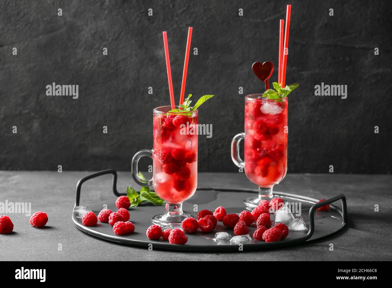 Cups of cold raspberry tea on dark background Stock Photo - Alamy
