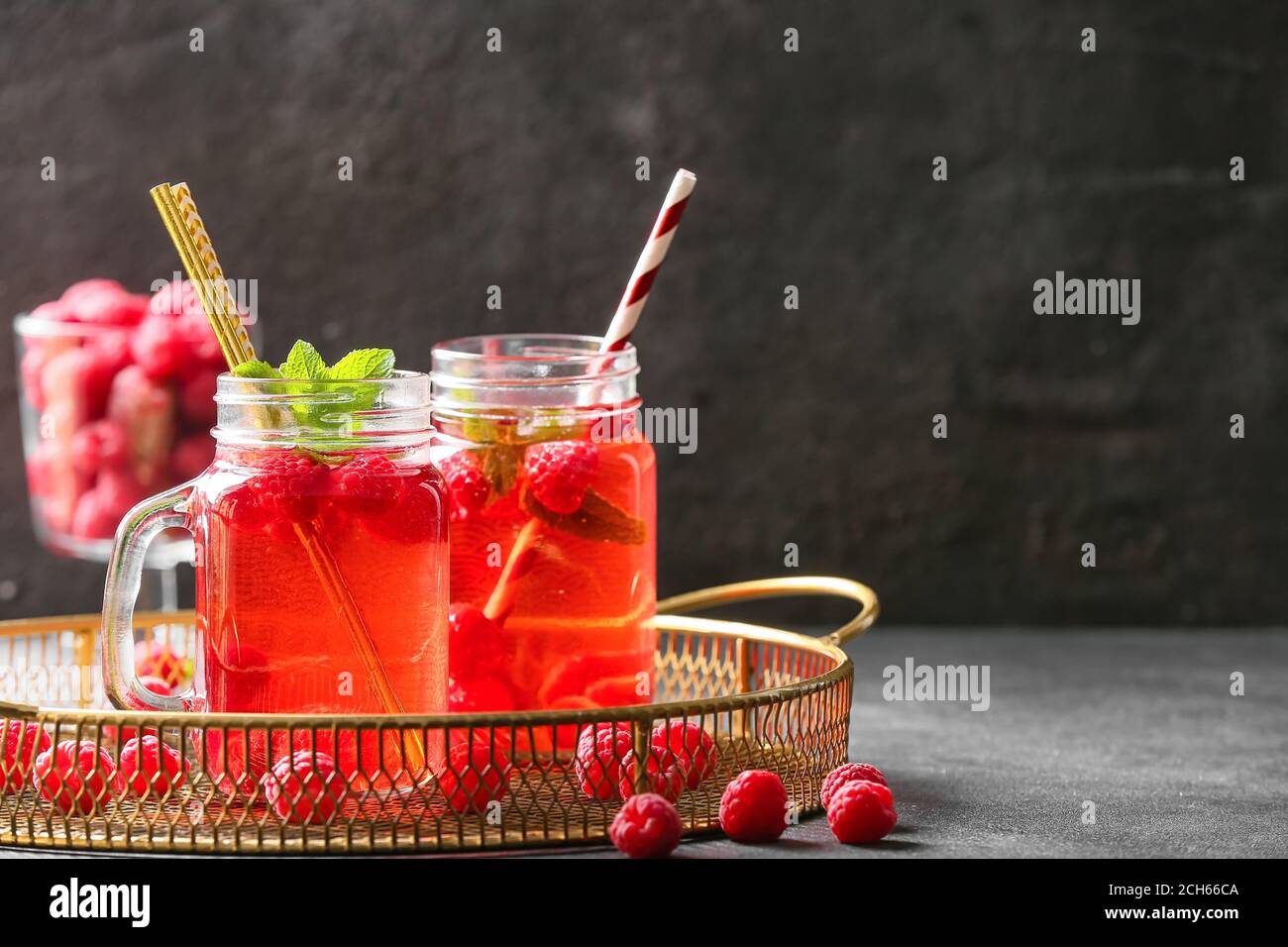 Mason jars of cold raspberry tea on dark background Stock Photo - Alamy