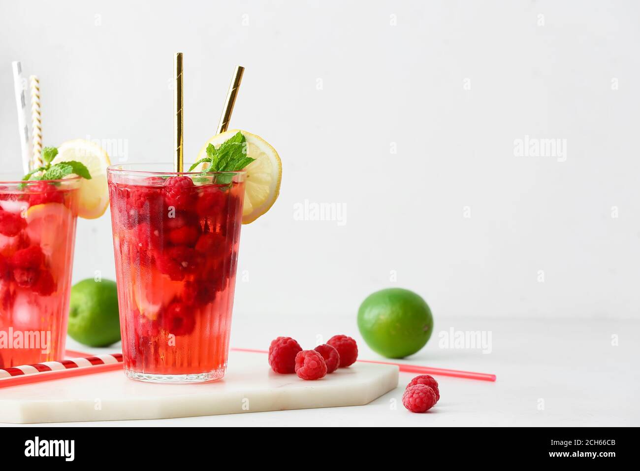 Glasses of cold raspberry tea on white background Stock Photo - Alamy