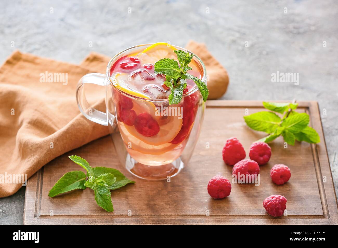 Cup of cold raspberry tea on grey background Stock Photo - Alamy