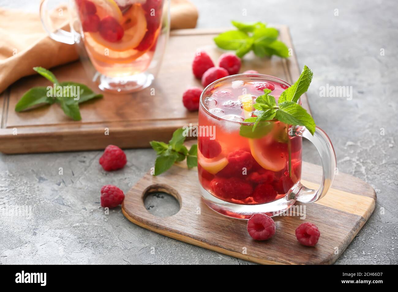 Cup of cold raspberry tea on grey background Stock Photo - Alamy