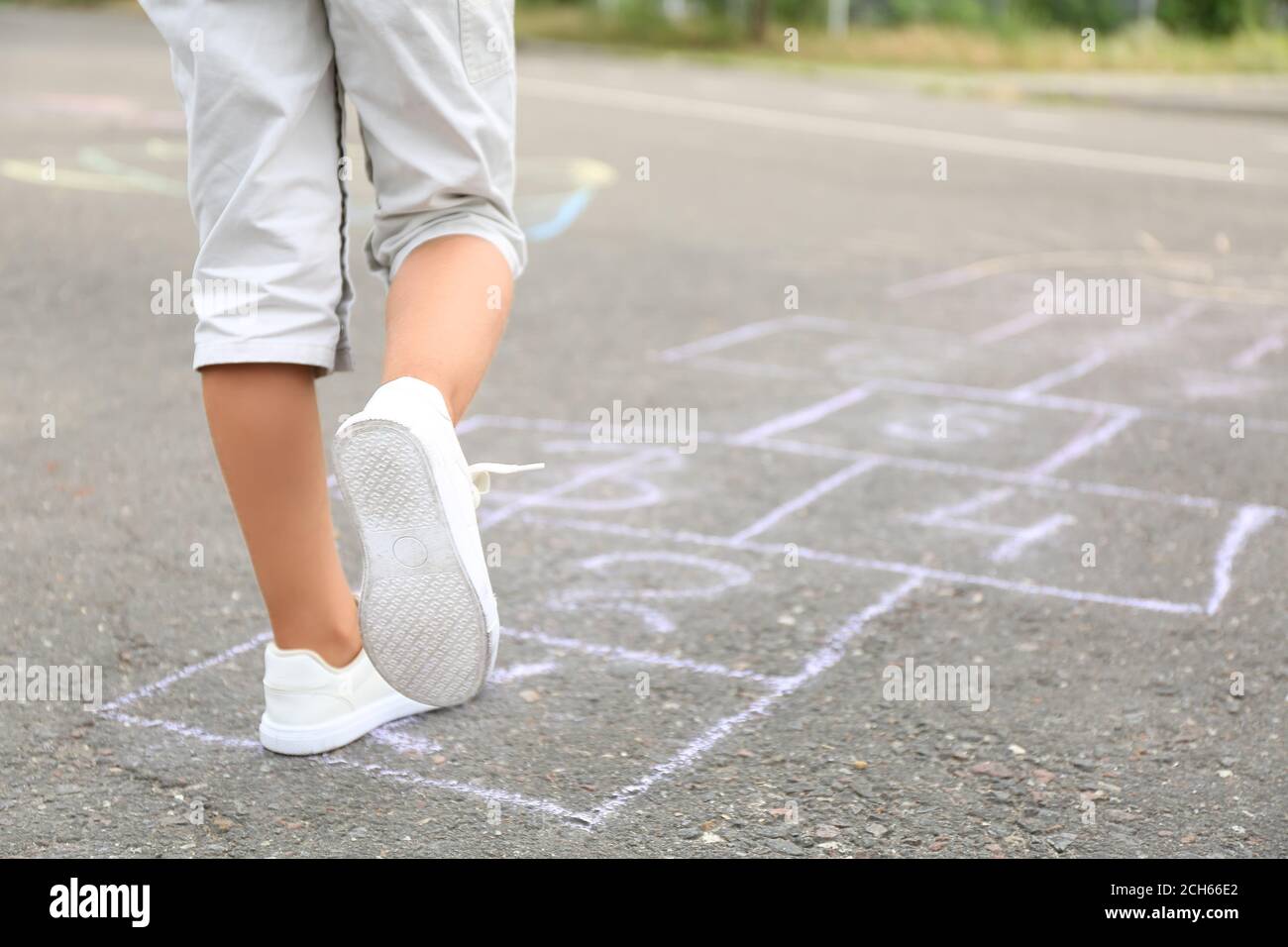 Little girl playing hopscotch outdoors Stock Photo - Alamy