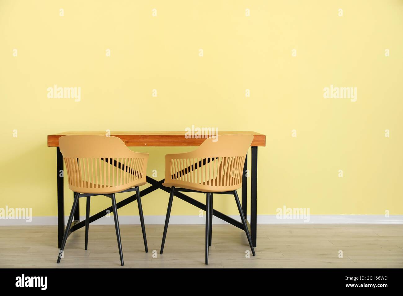 Dining table near color wall Stock Photo - Alamy