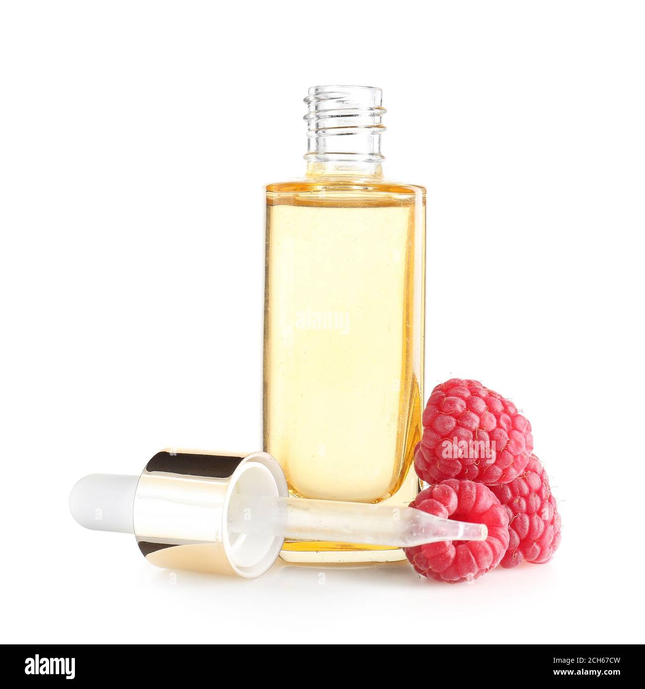 Bottle of raspberry essential oil on white background Stock Photo - Alamy