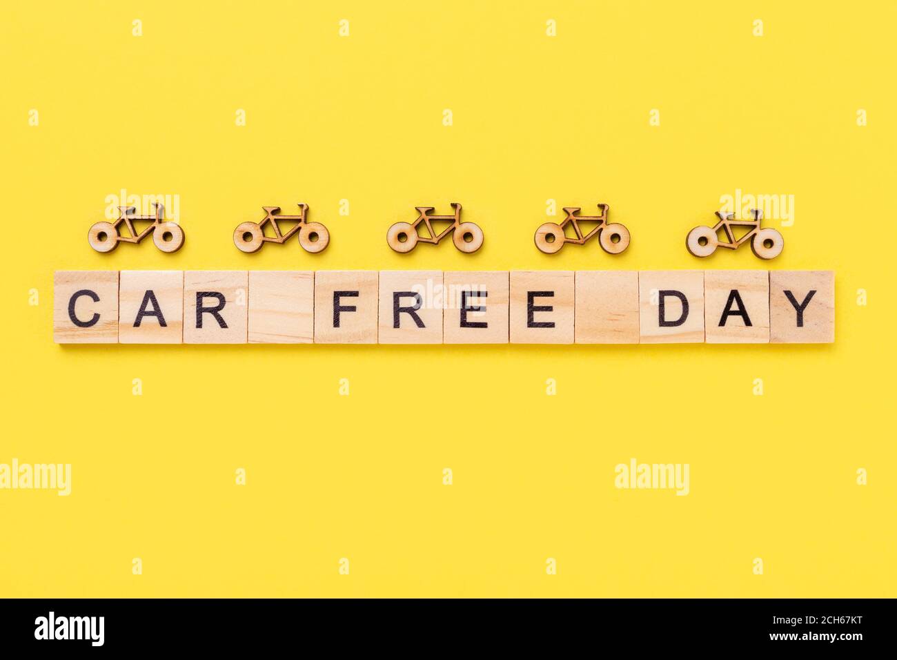 Text Car Free Day and small bicycles on yellow background. Concept of ... Text Car Free Day and small bicycles on yellow background. Concept of ...