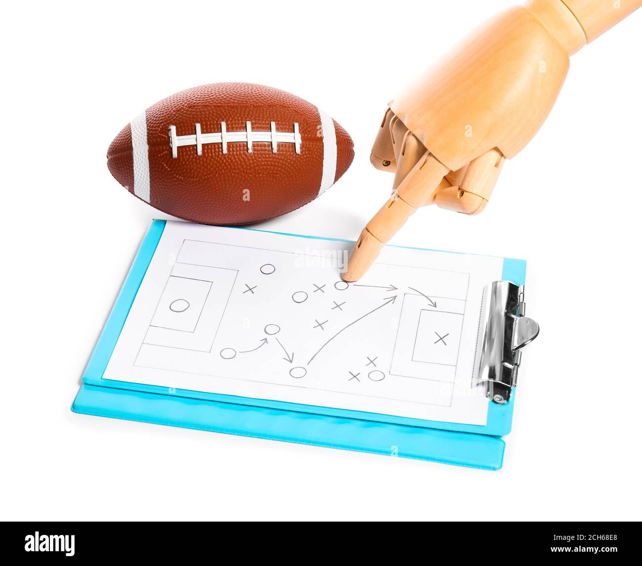 Hand of mannequin and rugby ball with scheme of football game on white ...