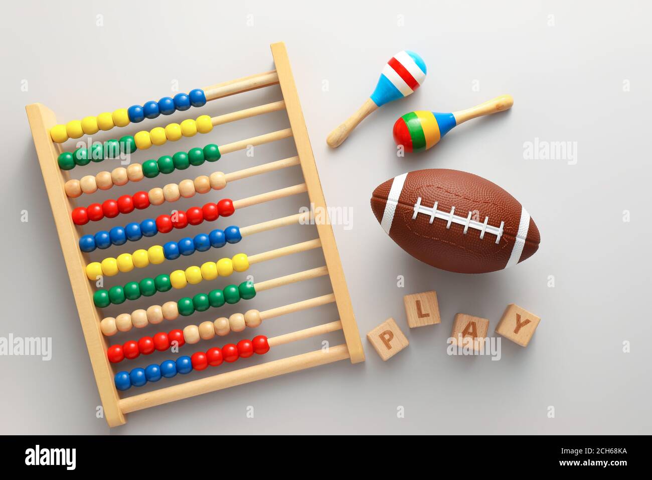 Rugby ball with kid toys and cubes with word PLAY on light background ...