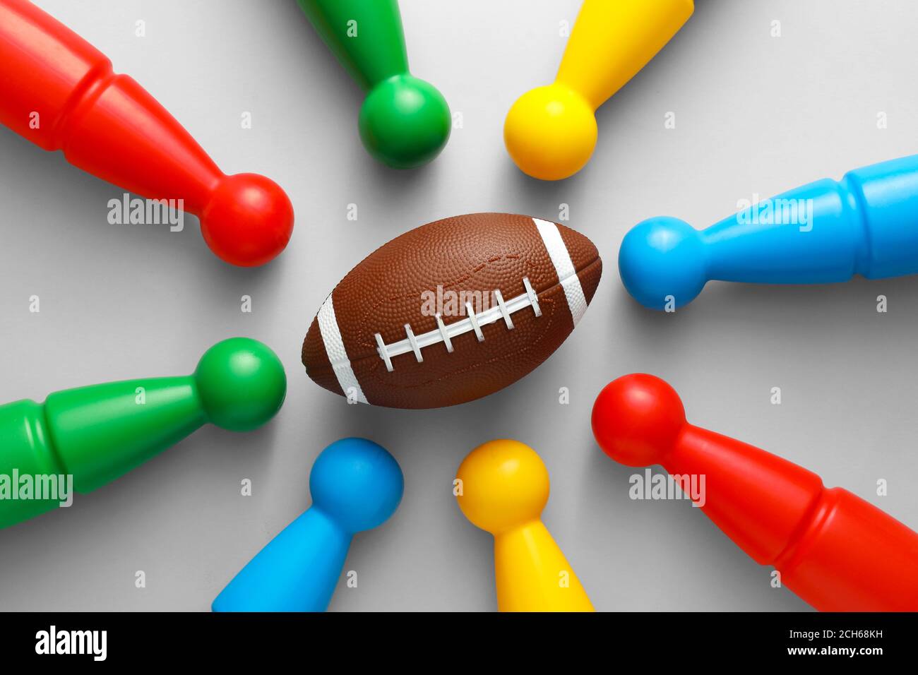 Rugby ball and bowling pins on grey background Stock Photo - Alamy
