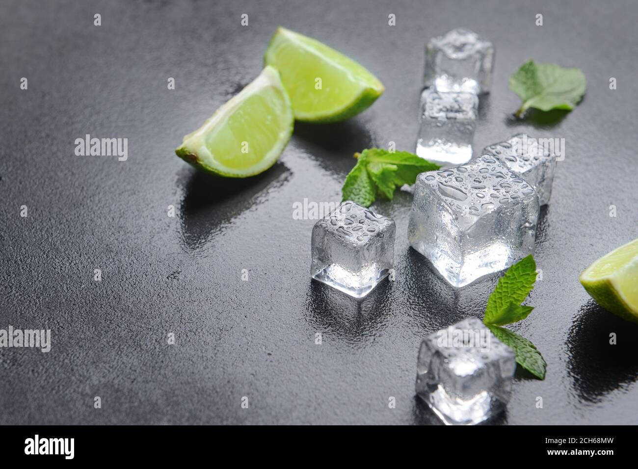 Ice cubes, lime and mint on dark background Stock Photo - Alamy