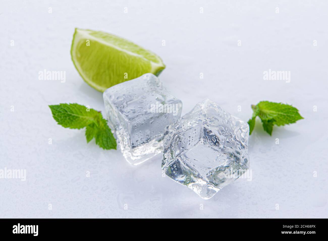 Ice cubes, lime and mint on white background Stock Photo - Alamy