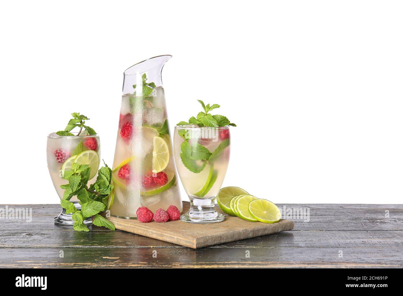 Glassware of fresh mojito on table against white background Stock Photo ...