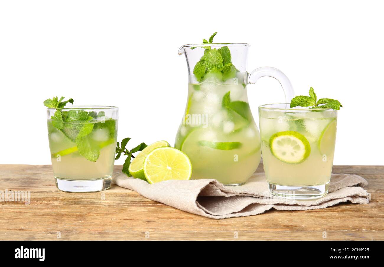 Glassware of fresh mojito on table against white background Stock Photo ...