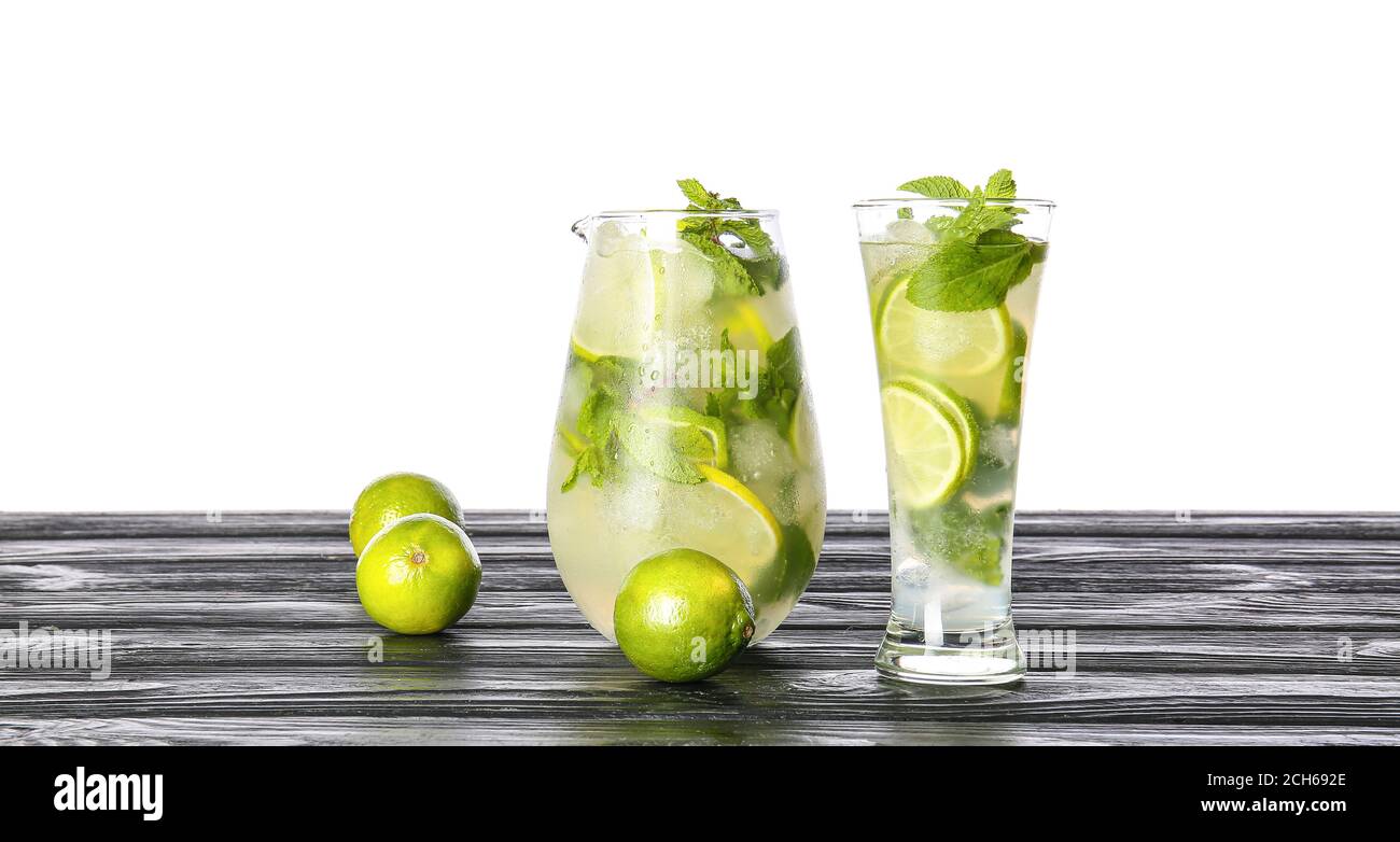 Glassware of fresh mojito on table against white background Stock Photo ...