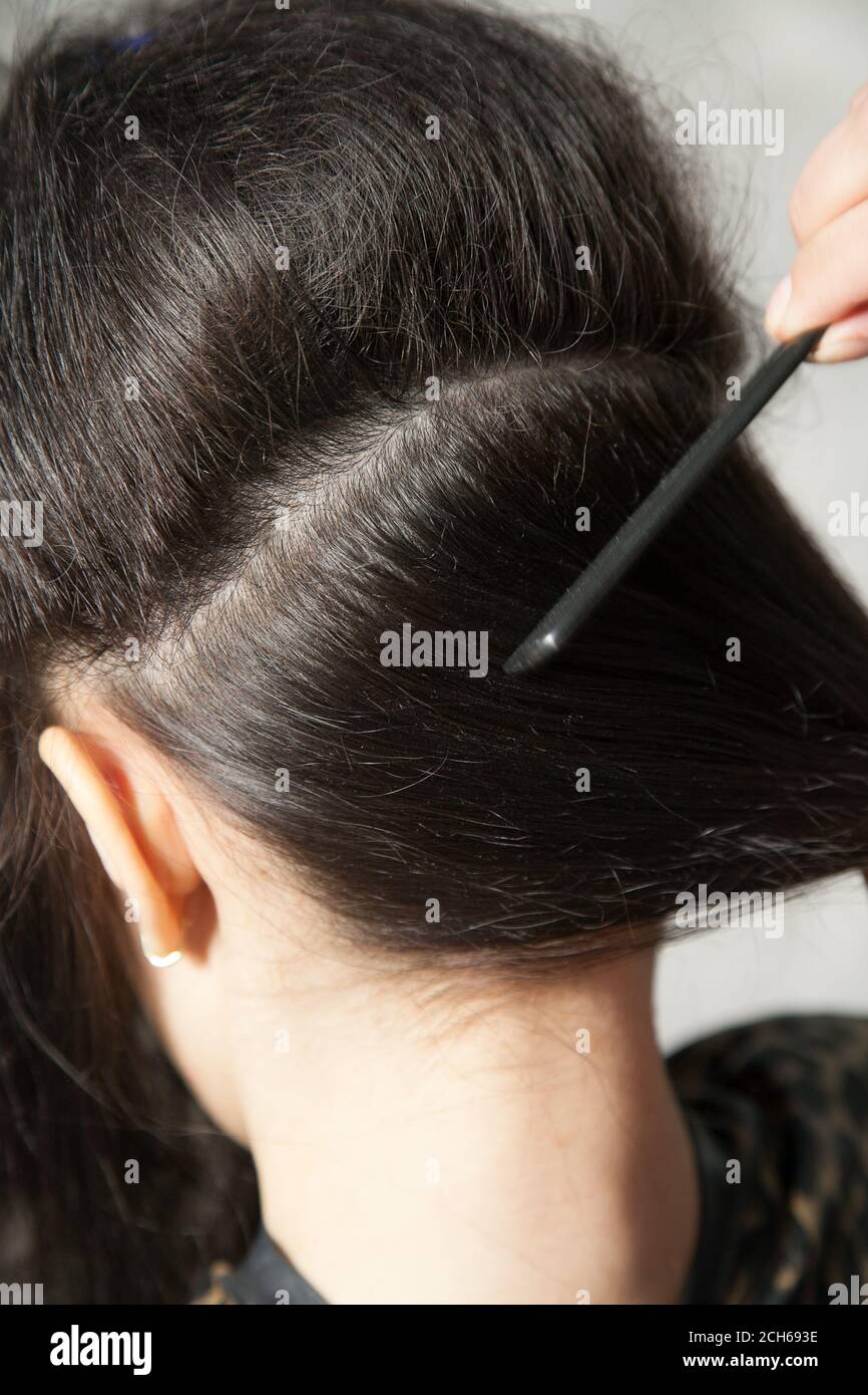 Closeup of combing back side hair part with selective focus Stock Photo ...