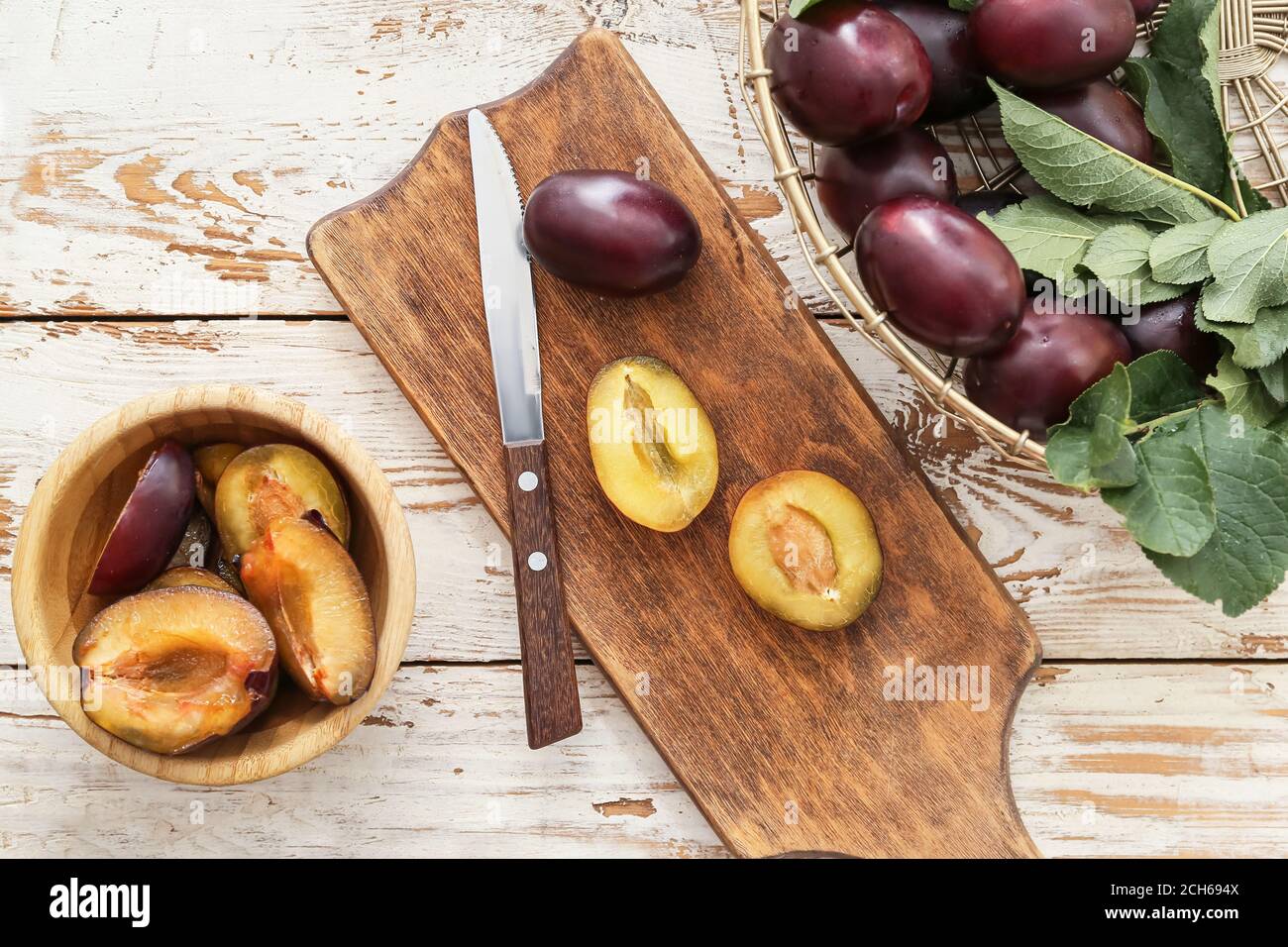 Tasty sweet plums on white wooden background Stock Photo - Alamy