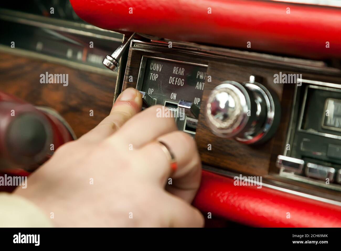 Switching convertible top button on an old vintage car with selective ...