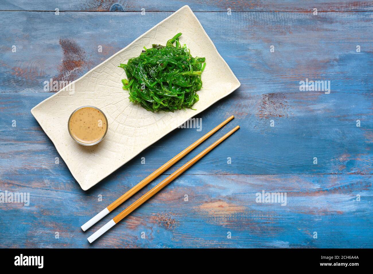 Plate with tasty seaweed salad on table Stock Photo - Alamy