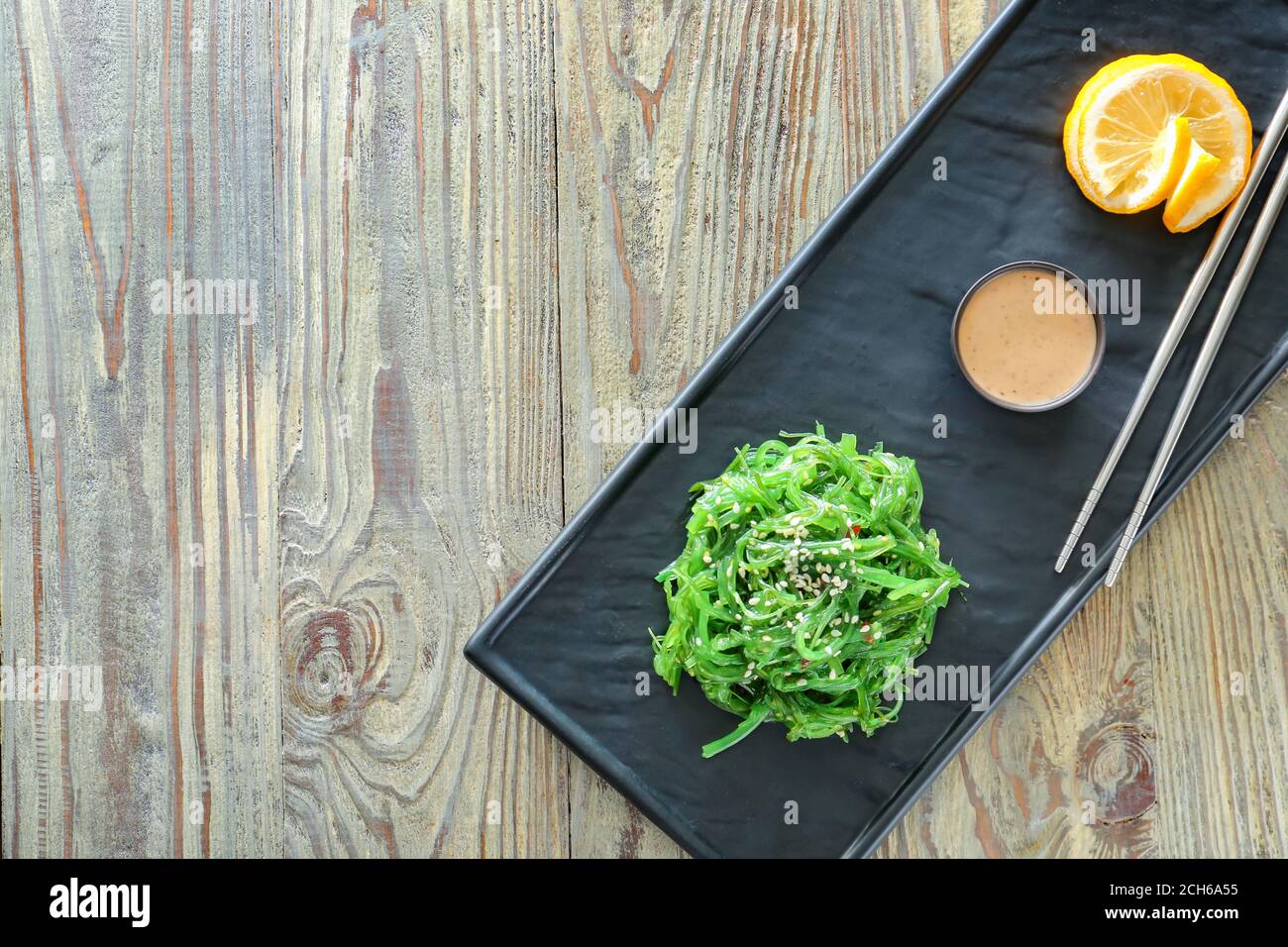 Plate with tasty seaweed salad on table Stock Photo - Alamy