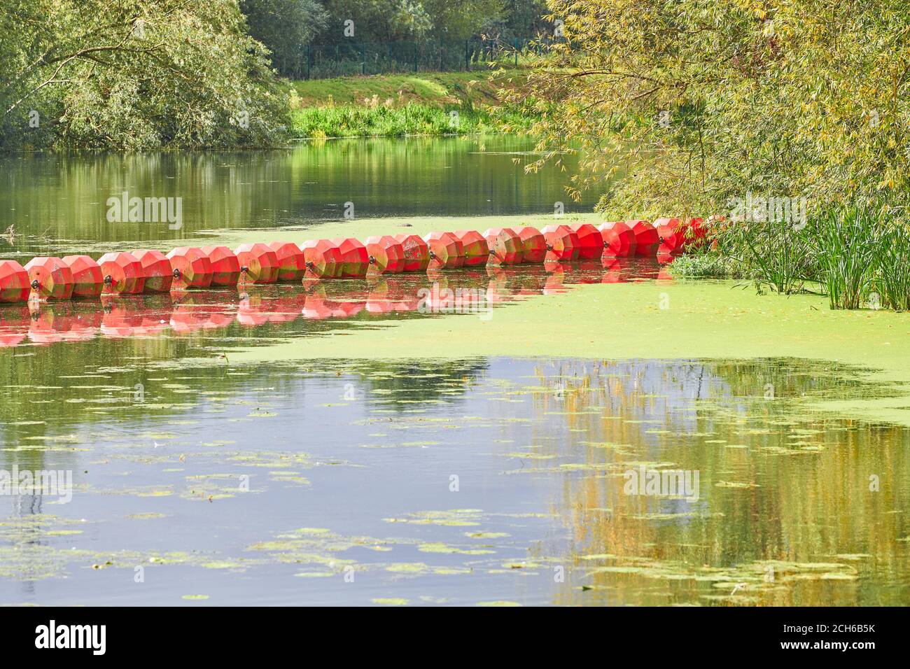 Clearly marked red barrier on the rive Nene above the weir next the ...