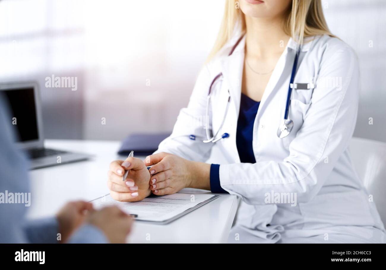 Unknown woman-doctor is prescribing some antibiotics for her patient ...