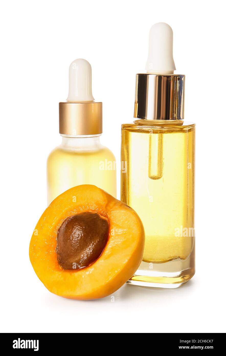 Bottles of apricot essential oil on white background Stock Photo - Alamy