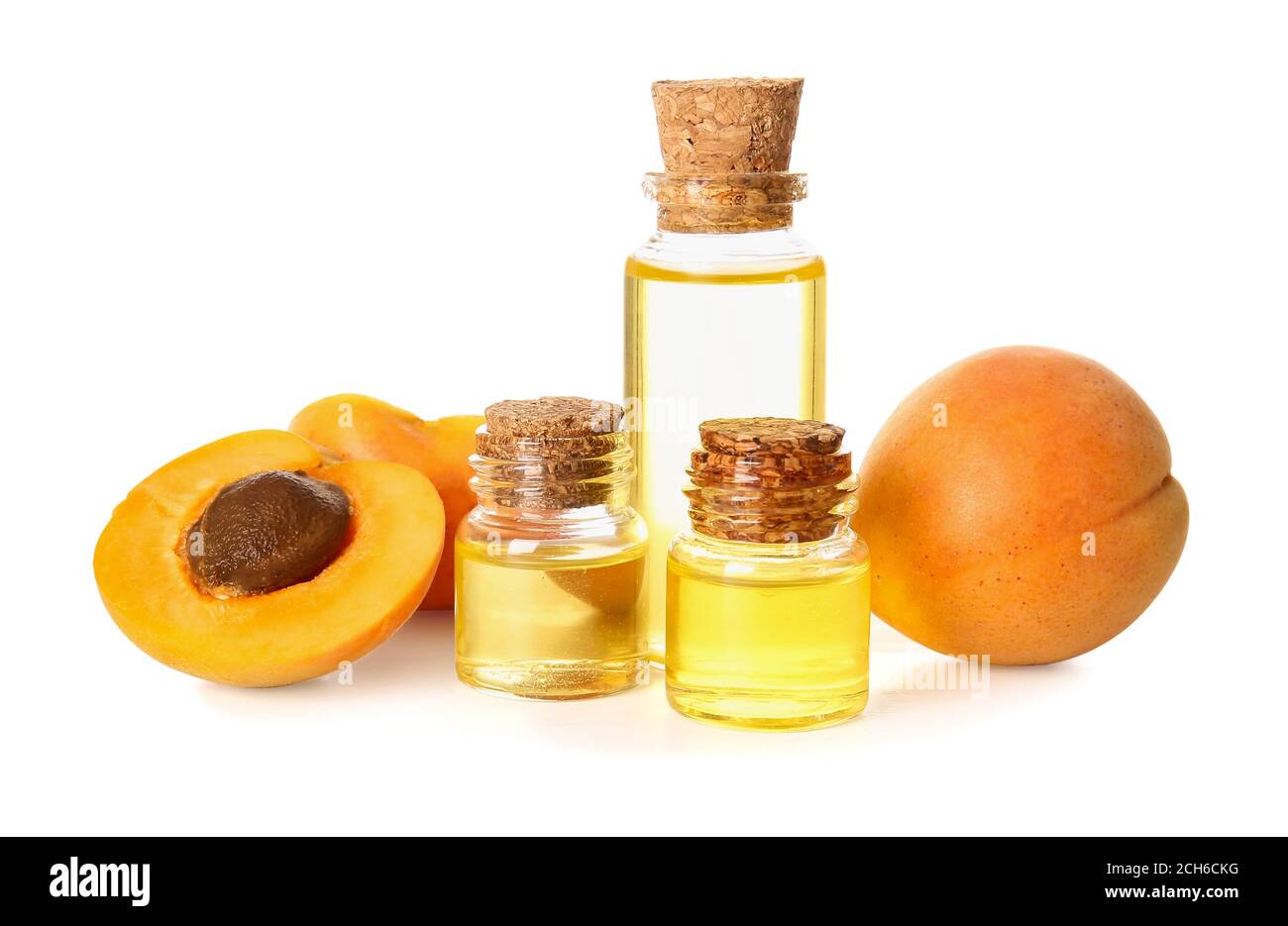 Bottles of apricot essential oil on white background Stock Photo - Alamy