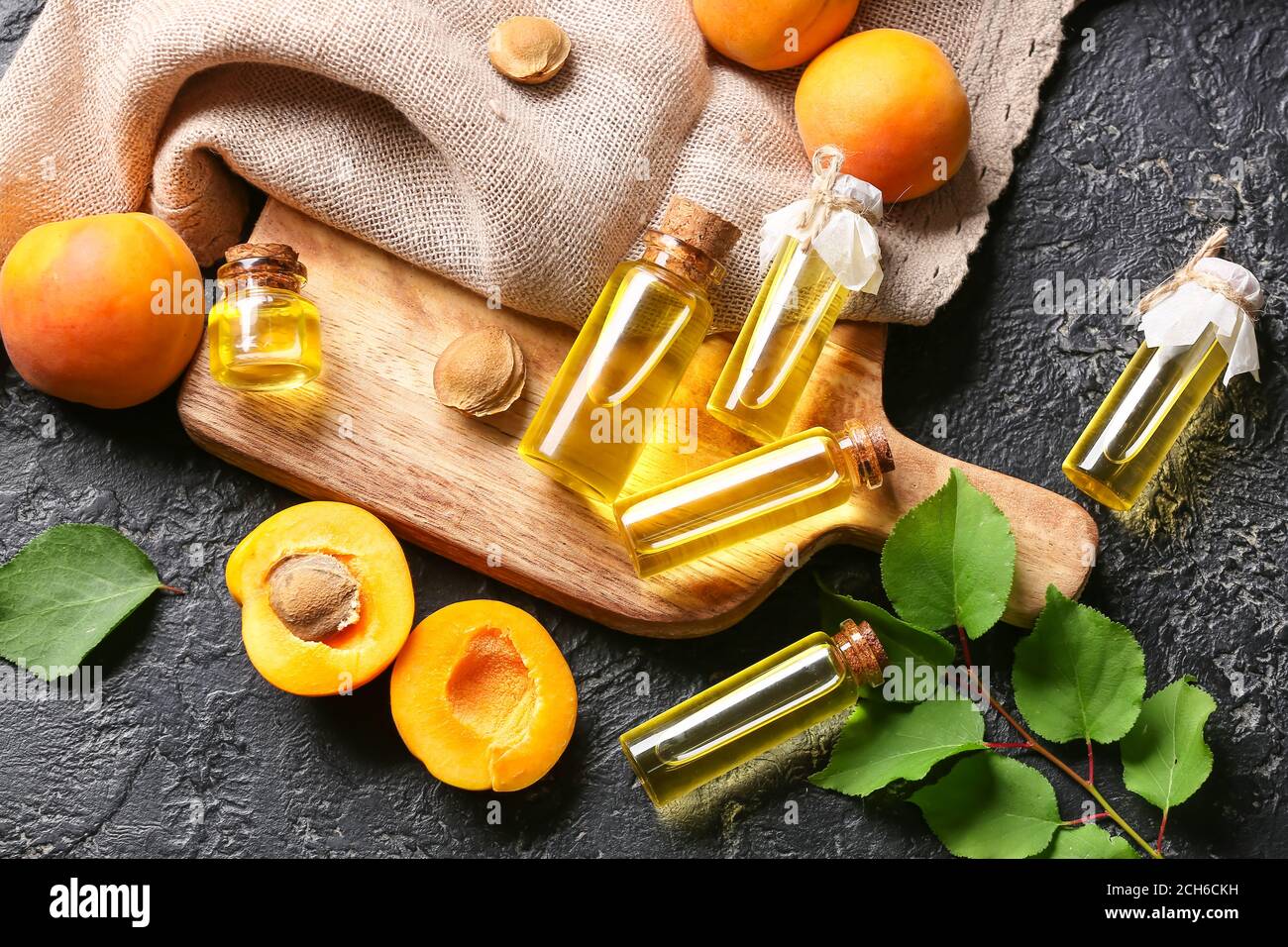 Bottles of apricot essential oil on dark background Stock Photo - Alamy