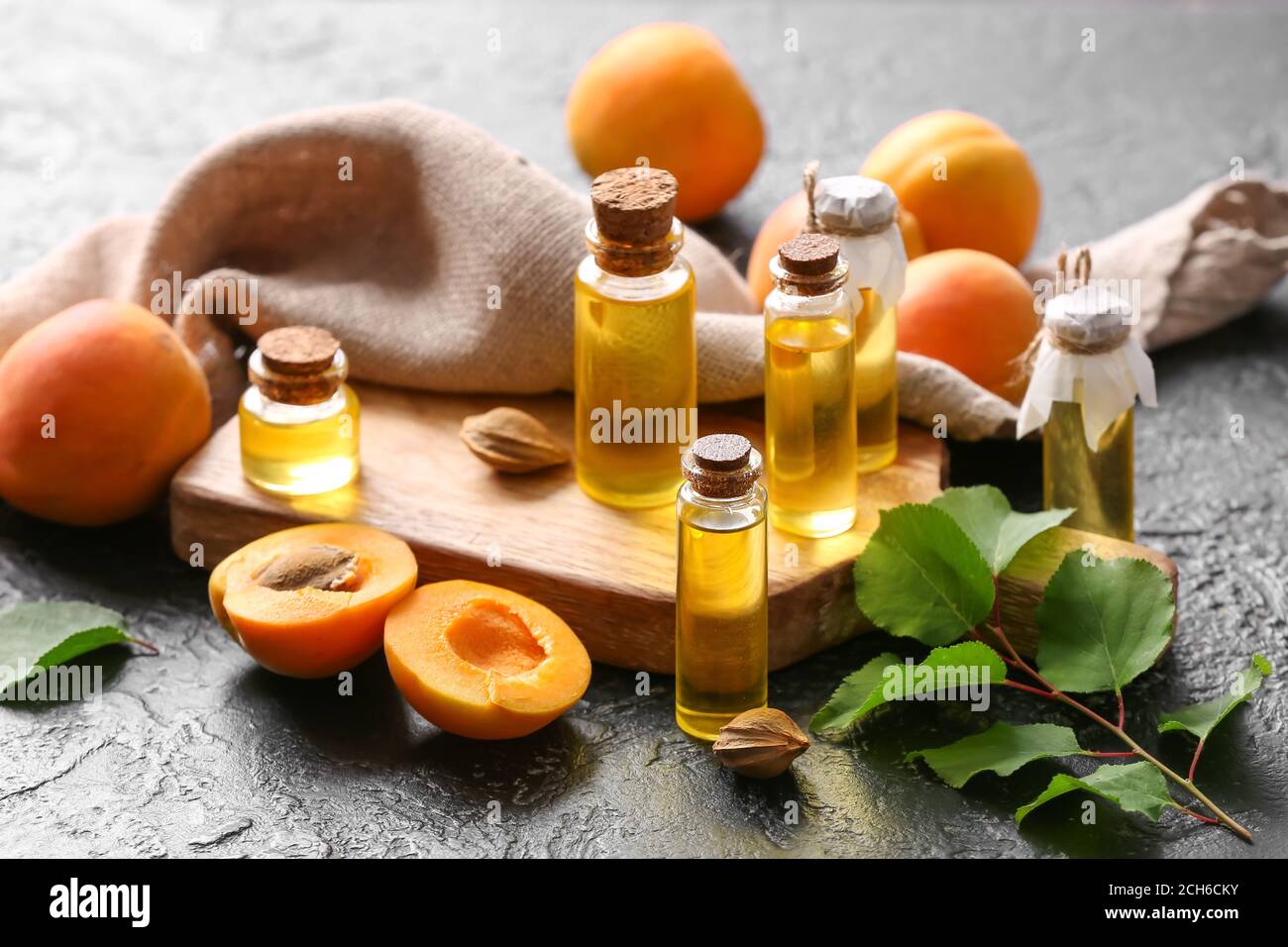 Bottles of apricot essential oil on dark background Stock Photo - Alamy