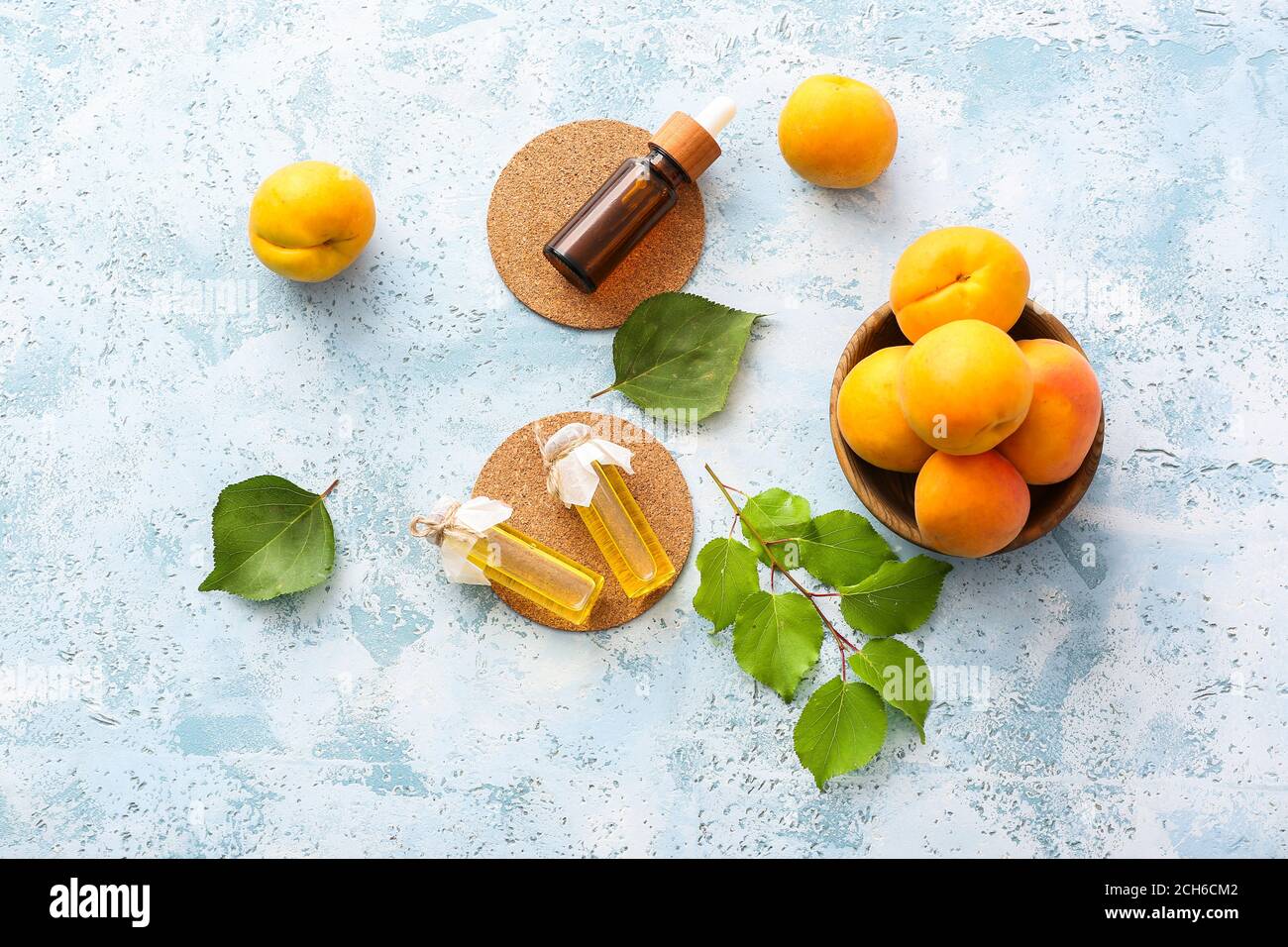 Bottles of apricot essential oil on color background Stock Photo - Alamy