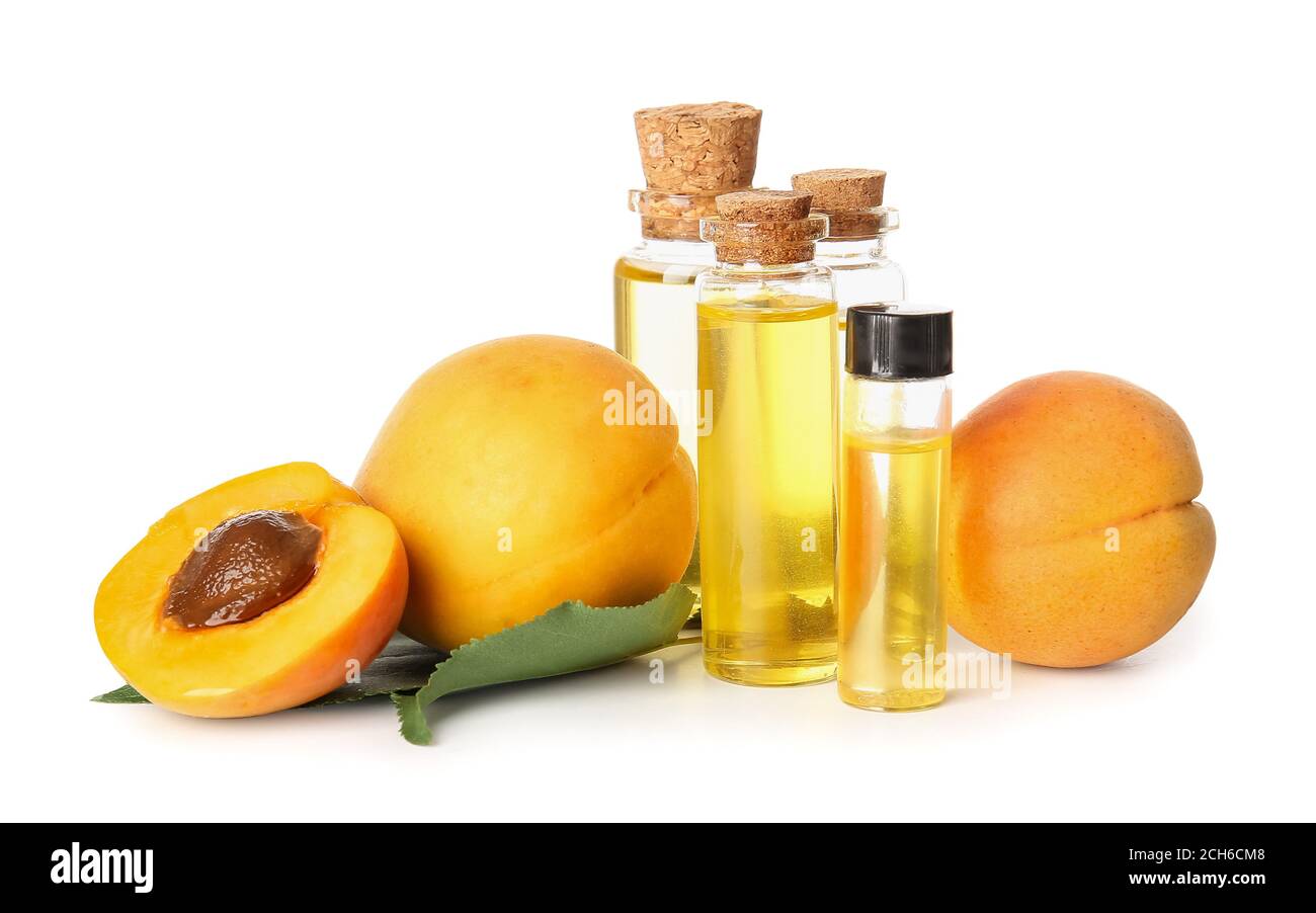 Bottles of apricot essential oil on white background Stock Photo - Alamy