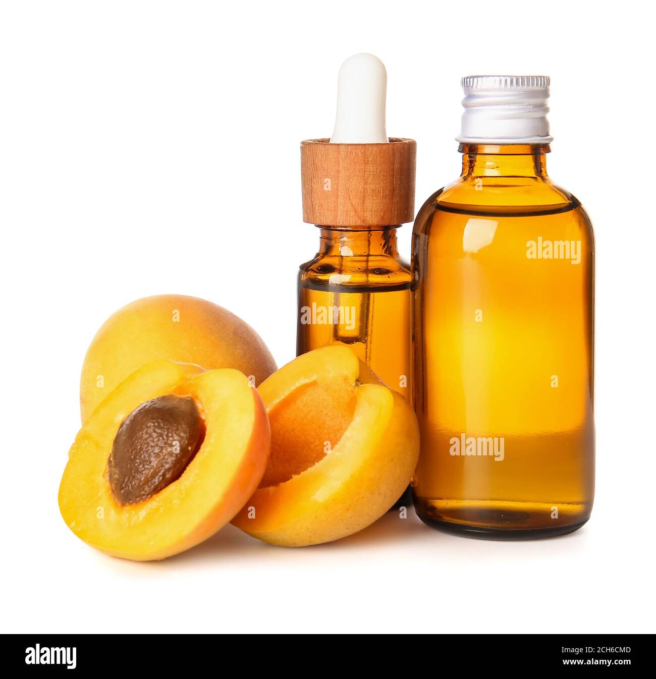 Bottles of apricot essential oil on white background Stock Photo - Alamy
