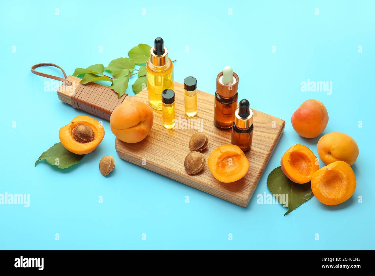 Bottles of apricot essential oil on color background Stock Photo - Alamy