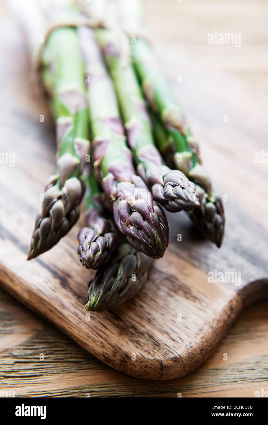 Fresh green asparagus on old wooden table Stock Photo - Alamy