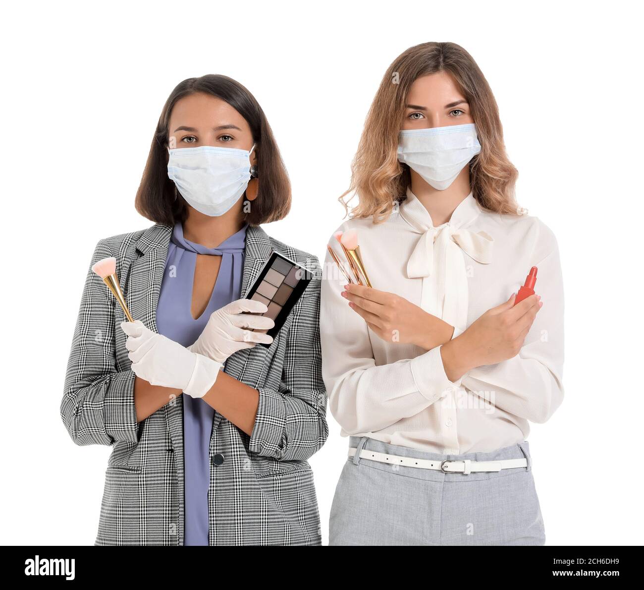 Female makeup artists wearing medical masks on white background ...