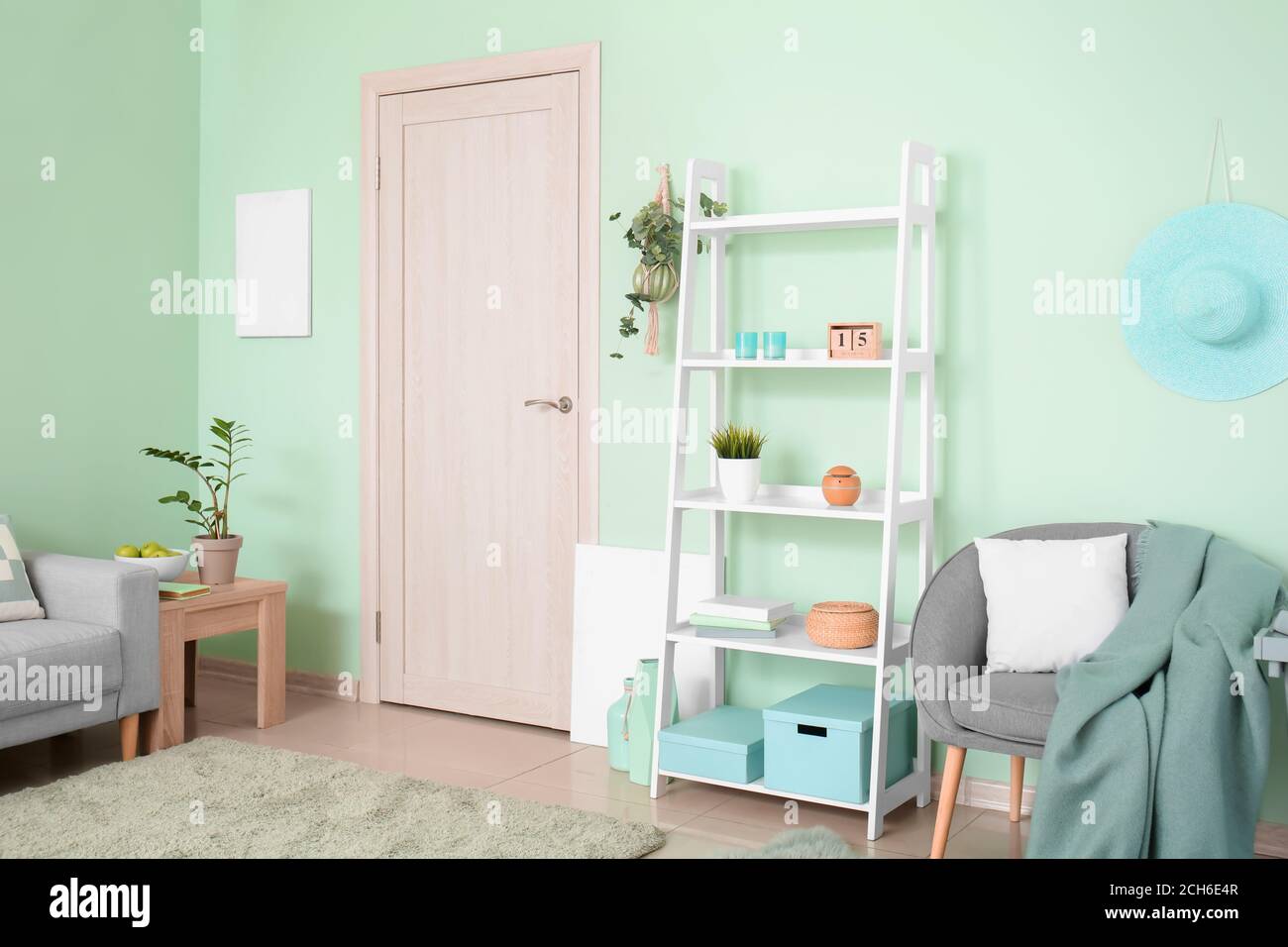 Interior of room with stylish mint wall Stock Photo - Alamy