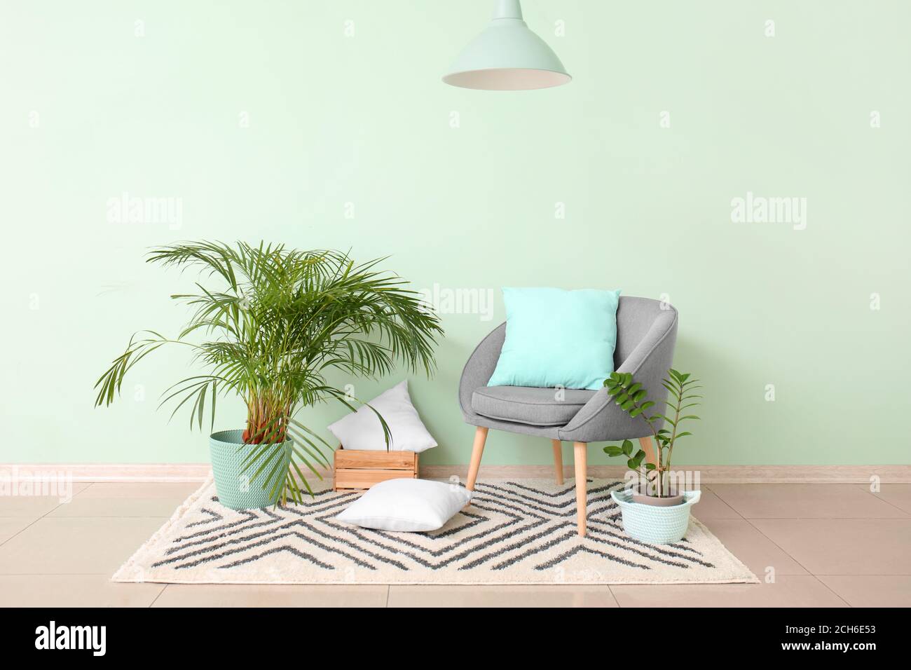 Interior of room with stylish mint wall Stock Photo - Alamy
