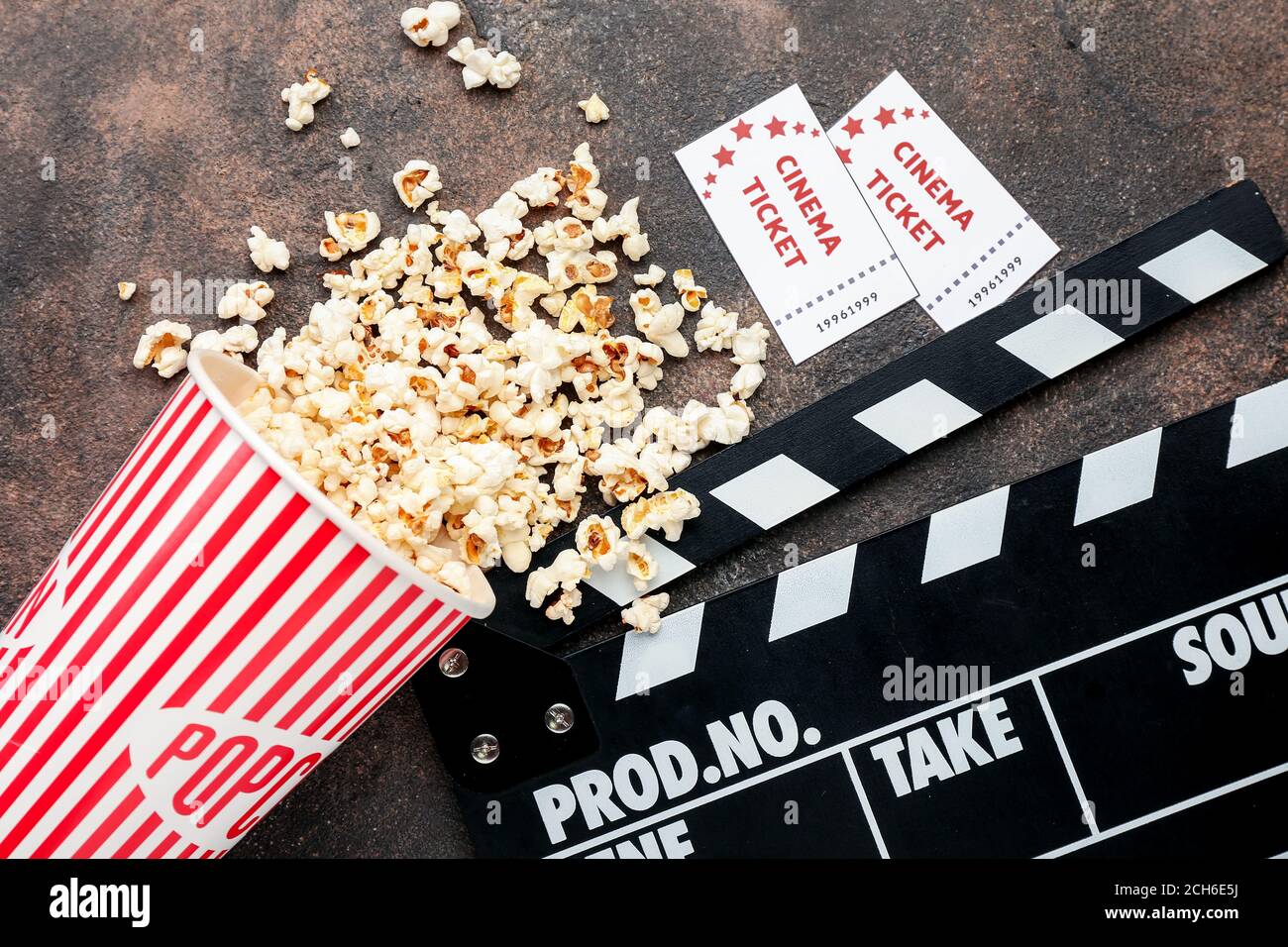 Popcorn, cinema tickets and movie clapper on grunge background Stock ...
