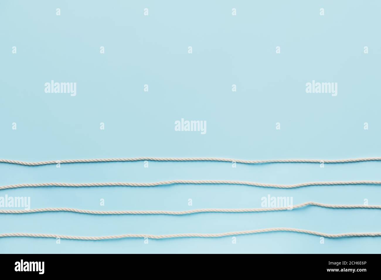 Long ropes on color background Stock Photo - Alamy