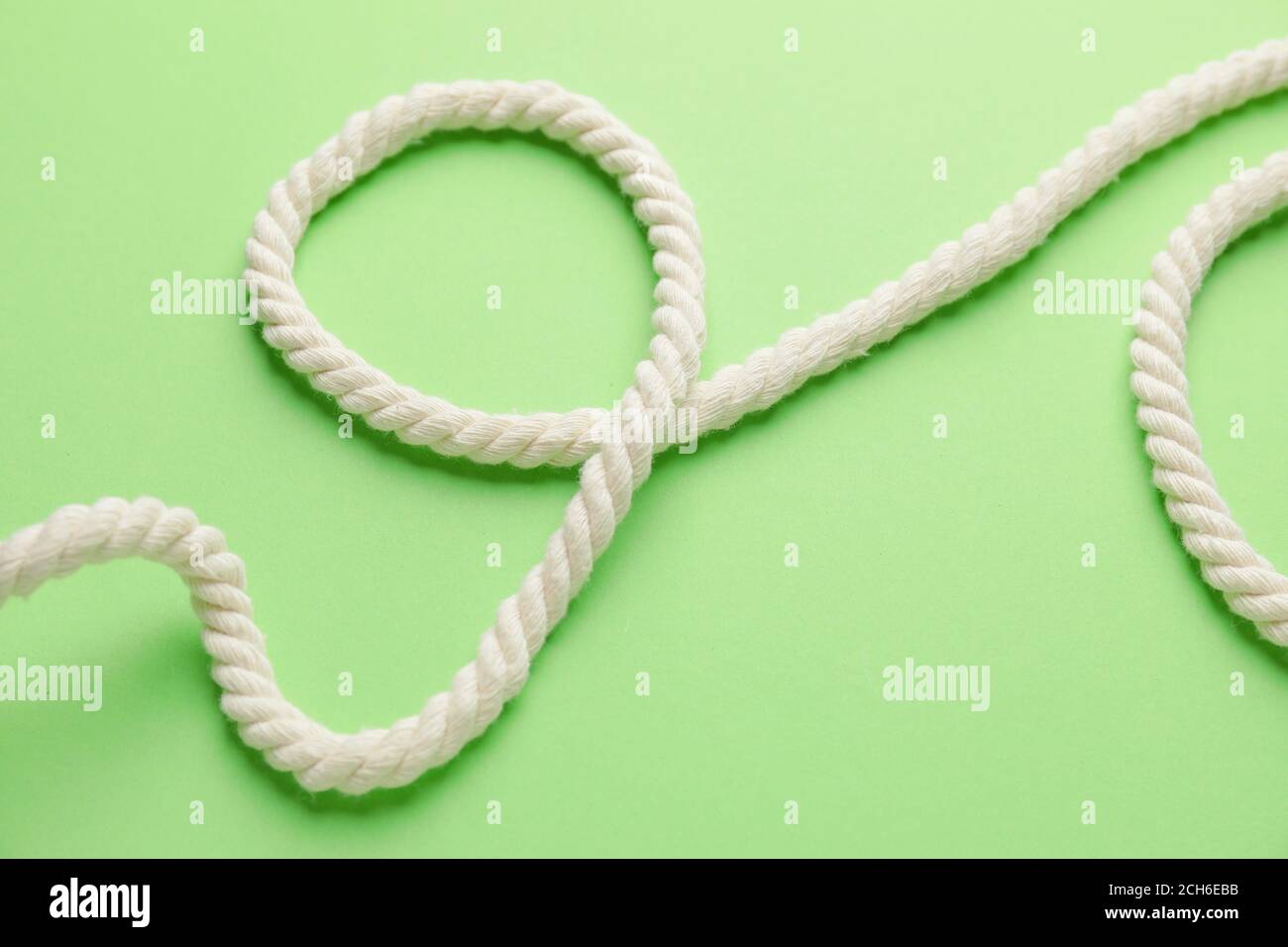Long rope on color background Stock Photo - Alamy