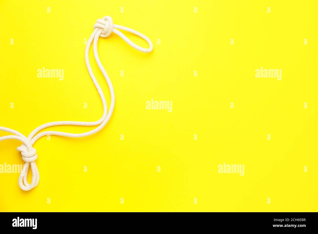 Rope with loops on color background Stock Photo - Alamy