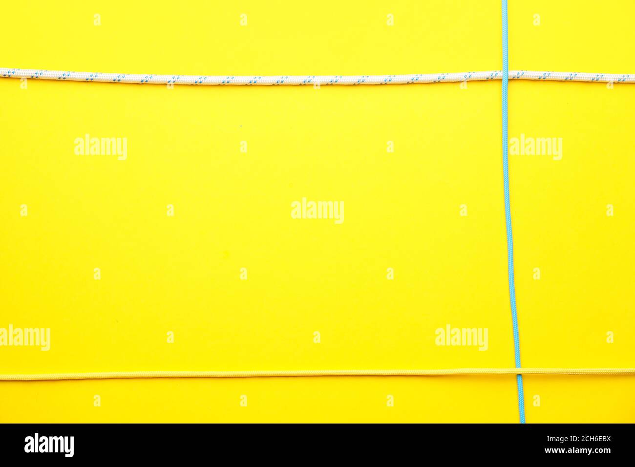Long ropes on color background Stock Photo - Alamy
