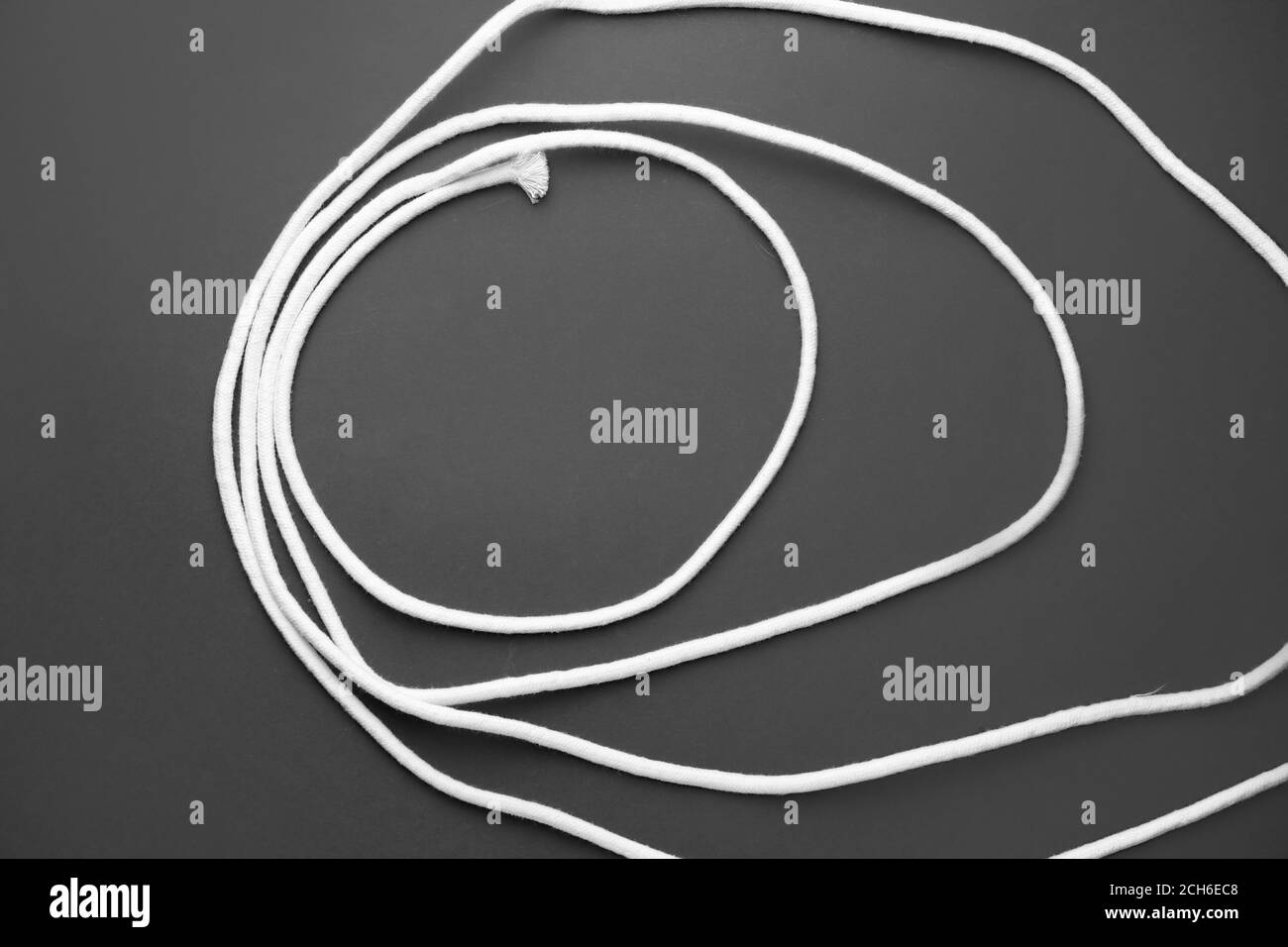 Long rope on dark background Stock Photo - Alamy