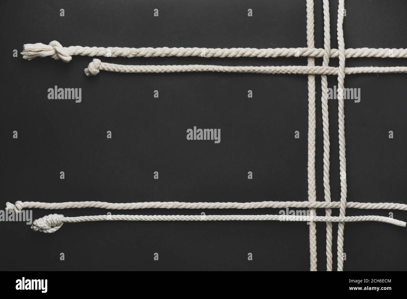 Long ropes on dark background Stock Photo - Alamy
