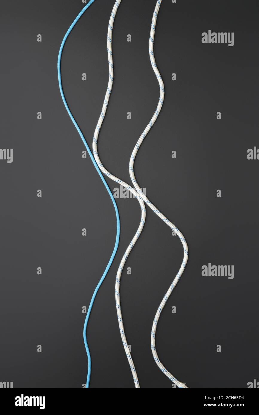 Long ropes on dark background Stock Photo - Alamy